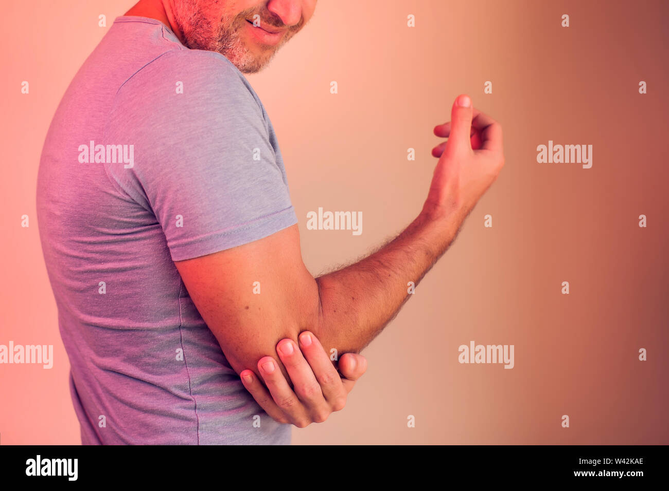 Man feels strong pain in elbow. People, healthcare and medicine concept ...