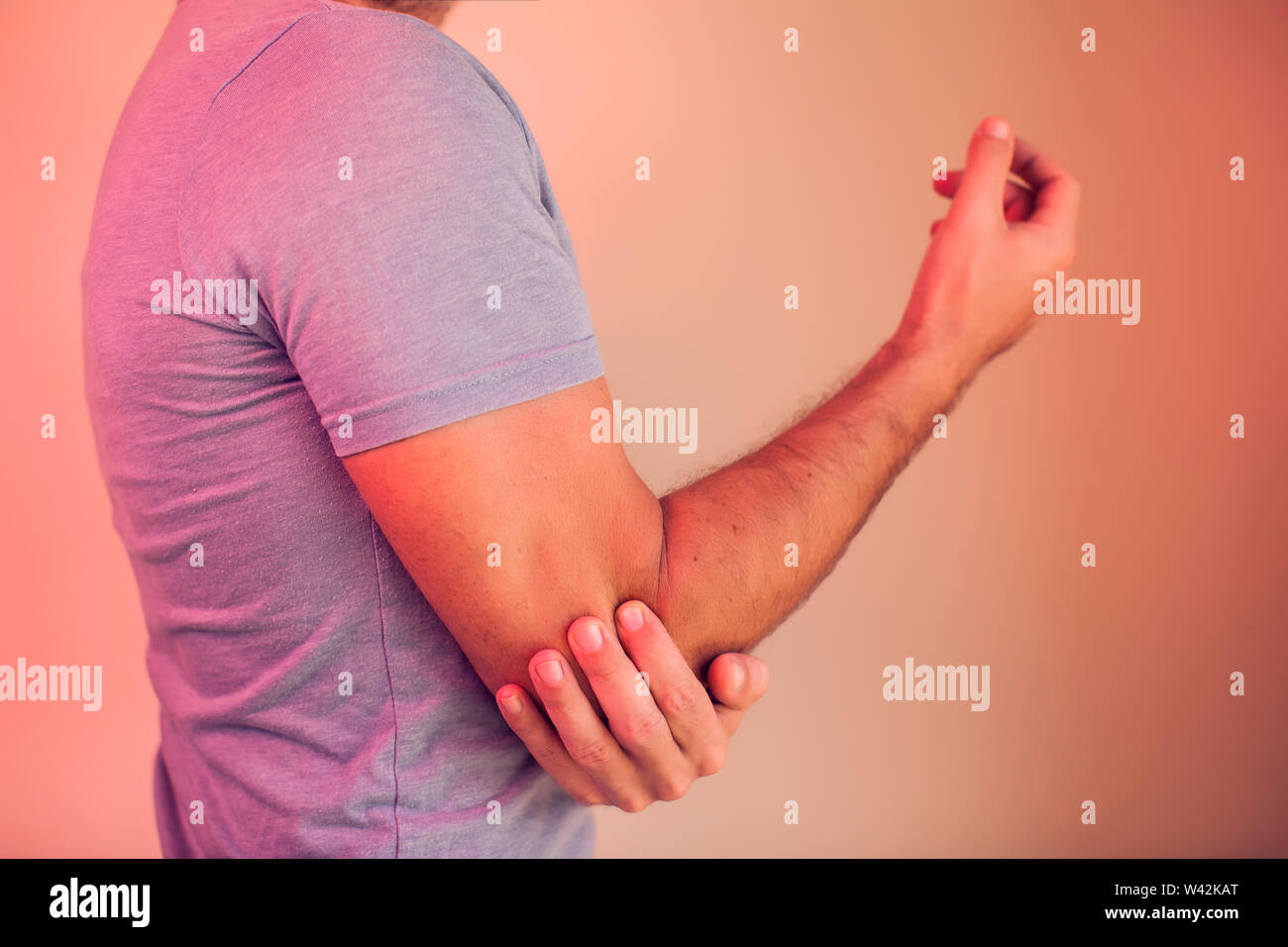Man feels strong pain in elbow. People, healthcare and medicine concept ...