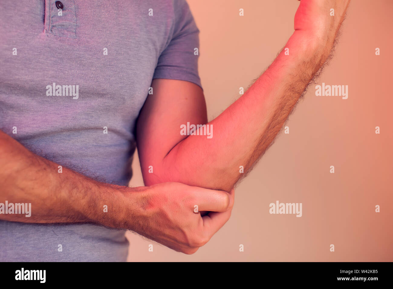 Man feels strong pain in elbow. People, healthcare and medicine concept ...
