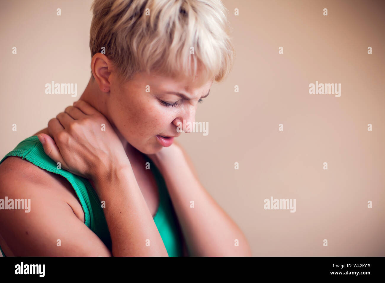 Woman with short hair feels strong neck pain isolated. People ...