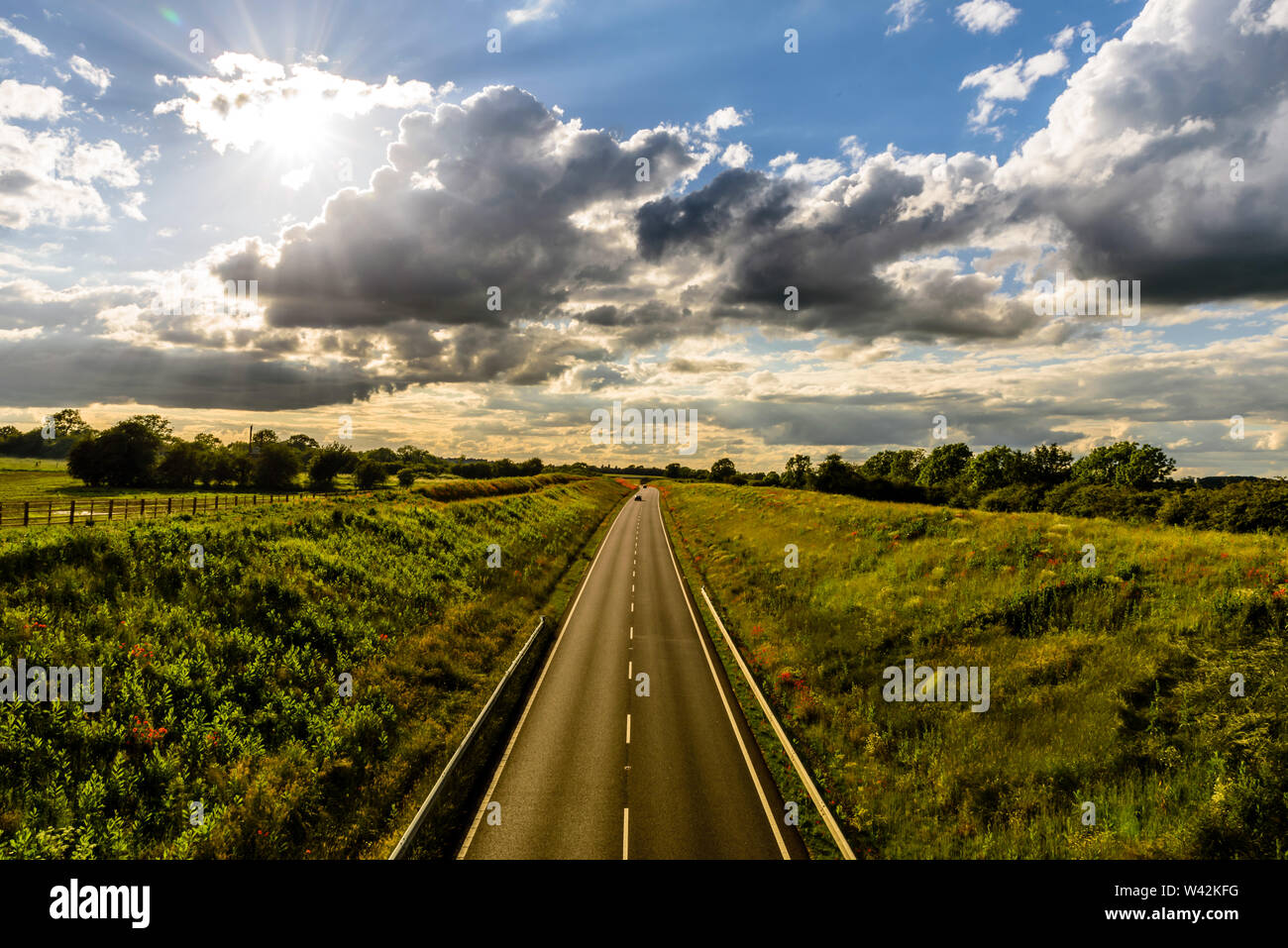empty uk motorway across colourful field on sunny day Stock Photo - Alamy