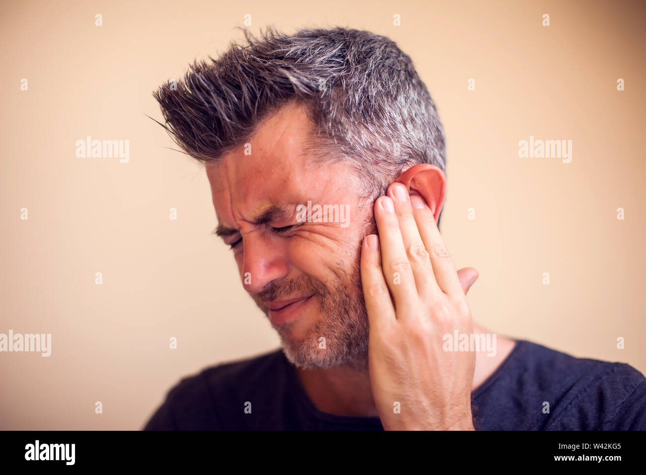 Man feels strong ear pain isolated. People, healthcare and medicine ...