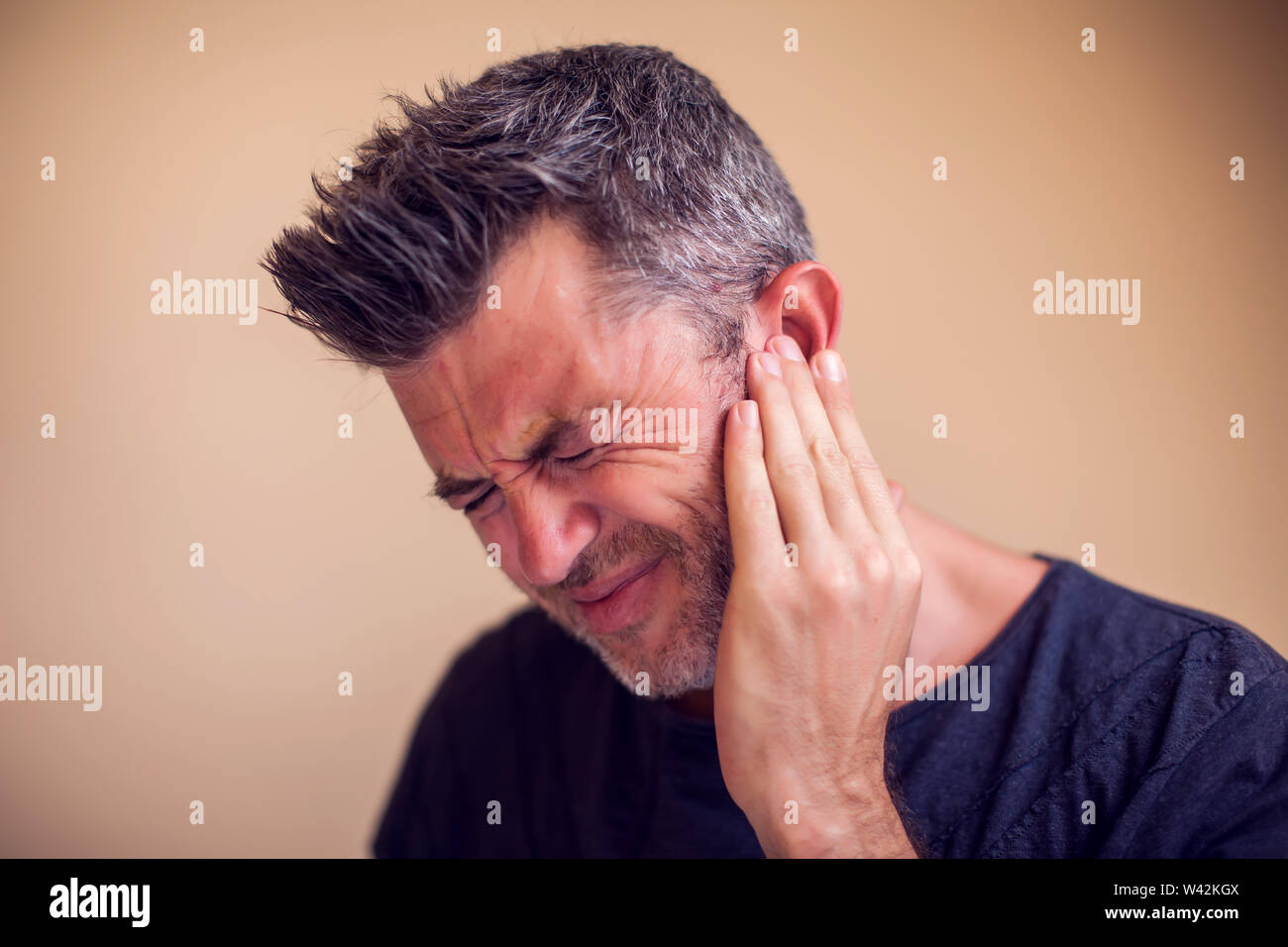 Man feels strong ear pain isolated. People, healthcare and medicine ...