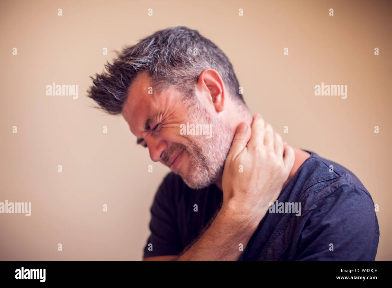 Man feels strong neck pain isolated. People, healthcare and medicine ...
