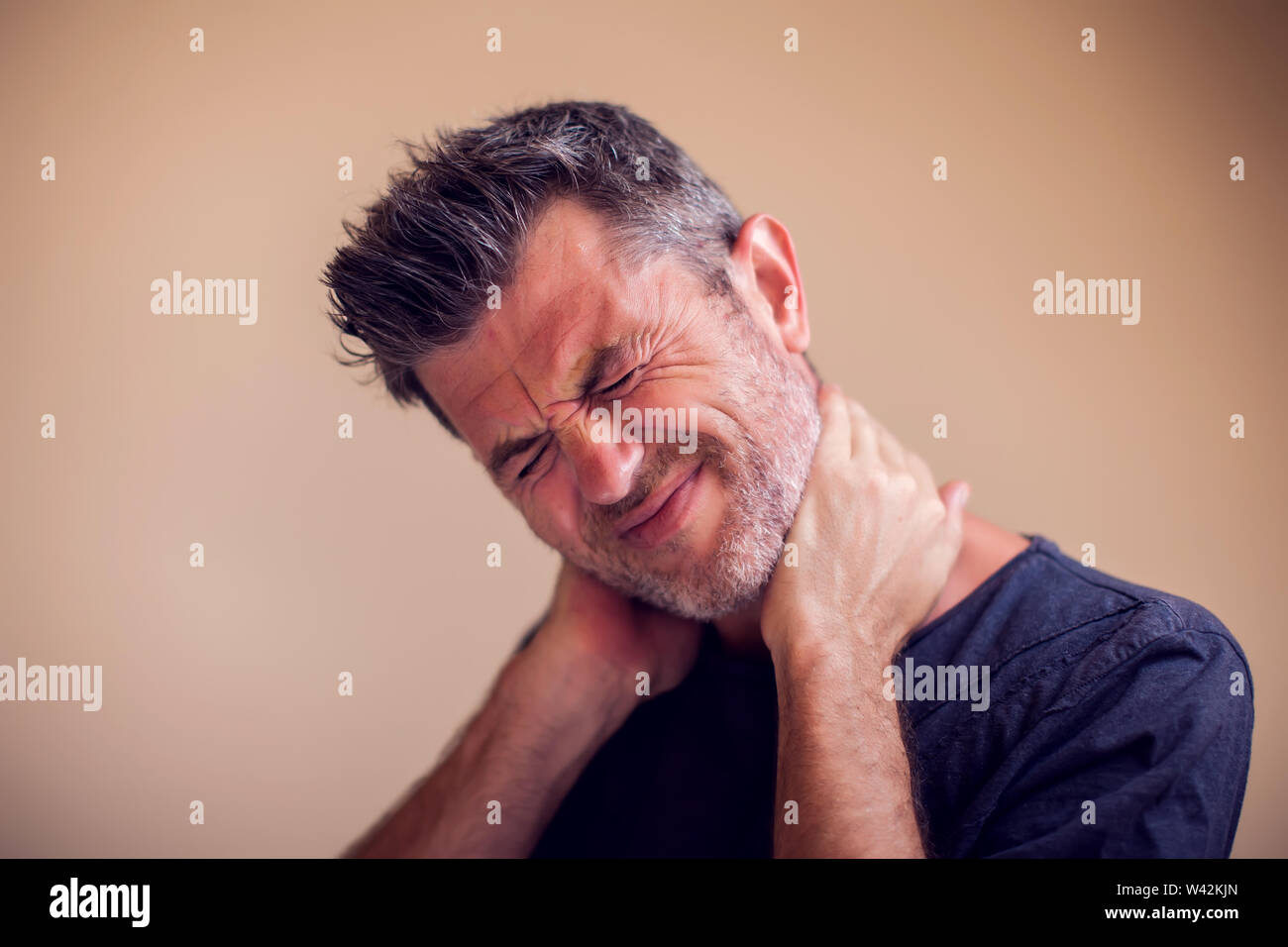 Man feels strong neck pain isolated. People, healthcare and medicine ...