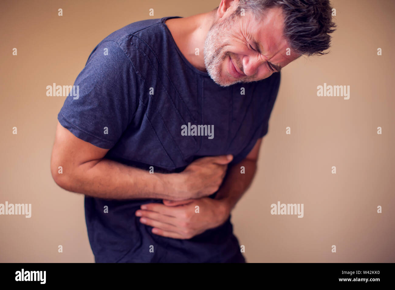 Man feels strong stomach ache isolated. People, healthcare and medicine ...