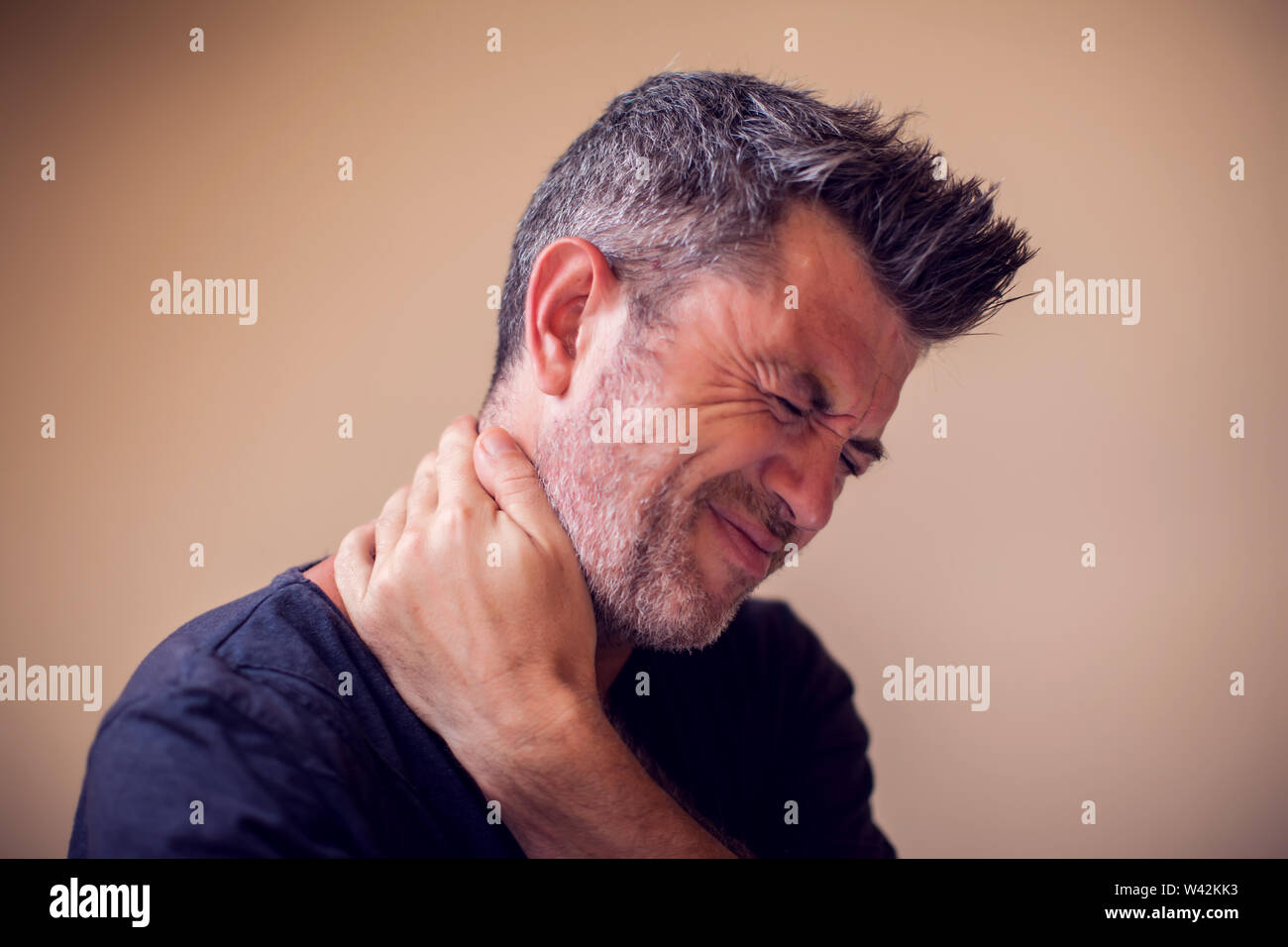 Man feels strong neck pain isolated. People, healthcare and medicine ...