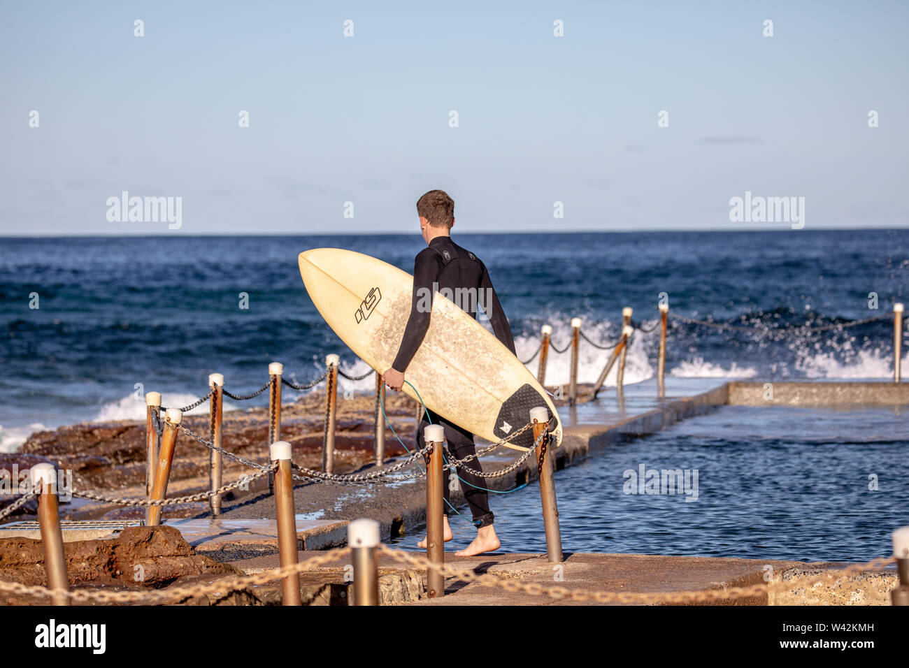 Surfer, man carrying his surfboard ready for a surfing afternoon on ...