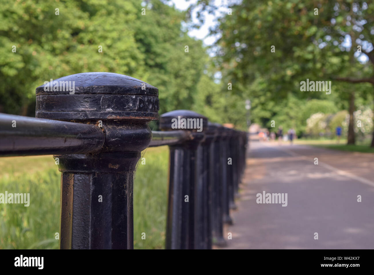 Close-up to an old black grating in profile. Diffuse background with ...