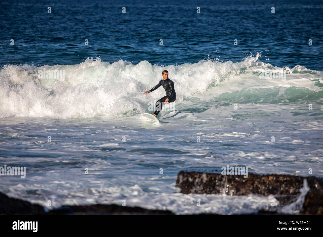 Surfing in Australia, man surfs on a winters day afternoon on Sydney ...