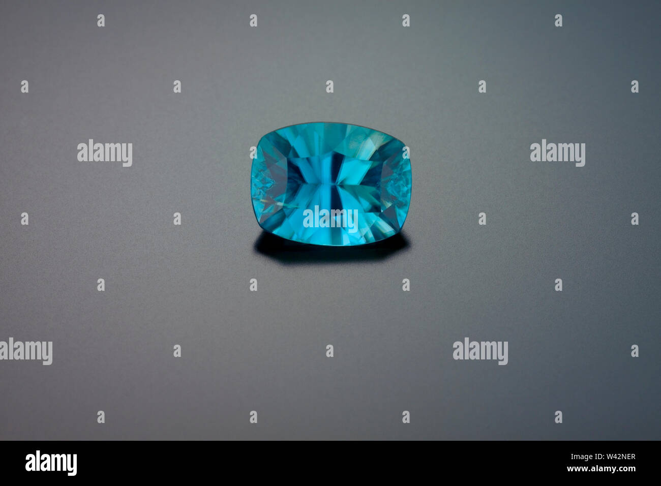 This single rectangle pincushion cut blue topaz gemstones is shown on a ...