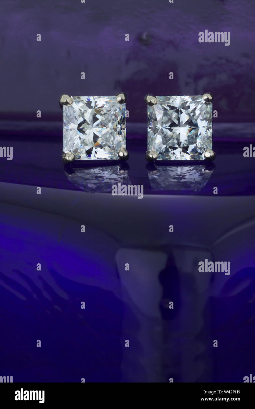 These square cut diamonds are mounted in four prong platinum earring ...