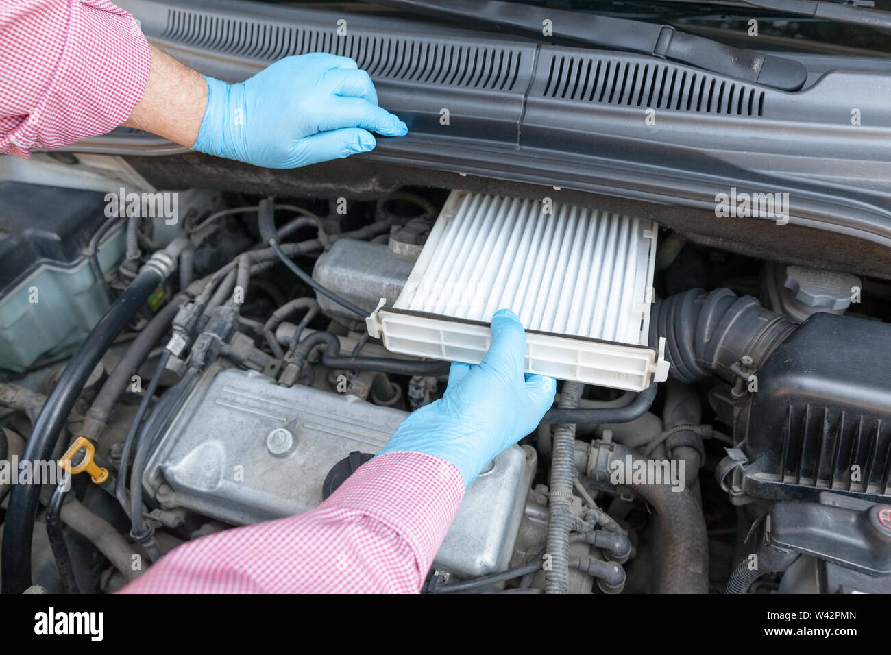 Inserting new cabin pollen air filter for a car Stock Photo - Alamy