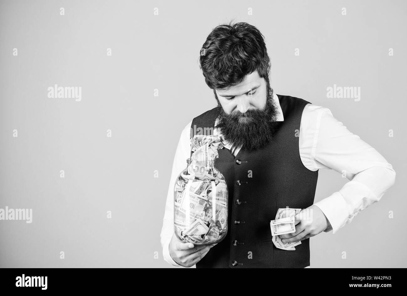 Man stuffing pockets cash hi-res stock photography and images - Alamy