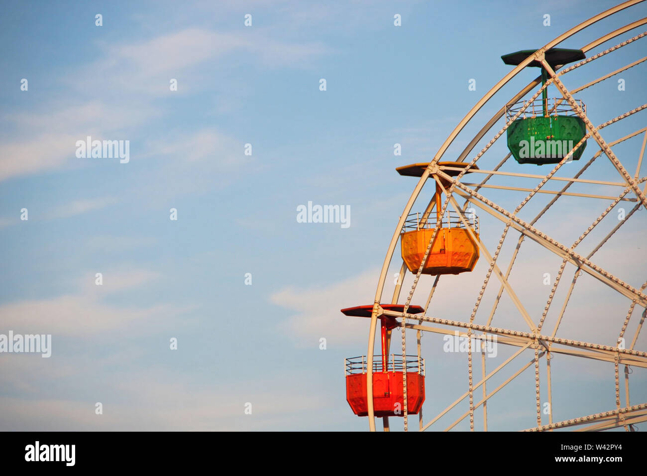 Multi-colored ferris wheel in an amusement park Stock Photo - Alamy