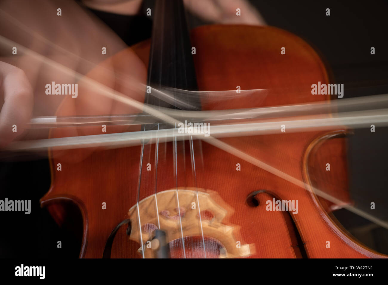 A young cellist practices intensely in this close up high resolution ...