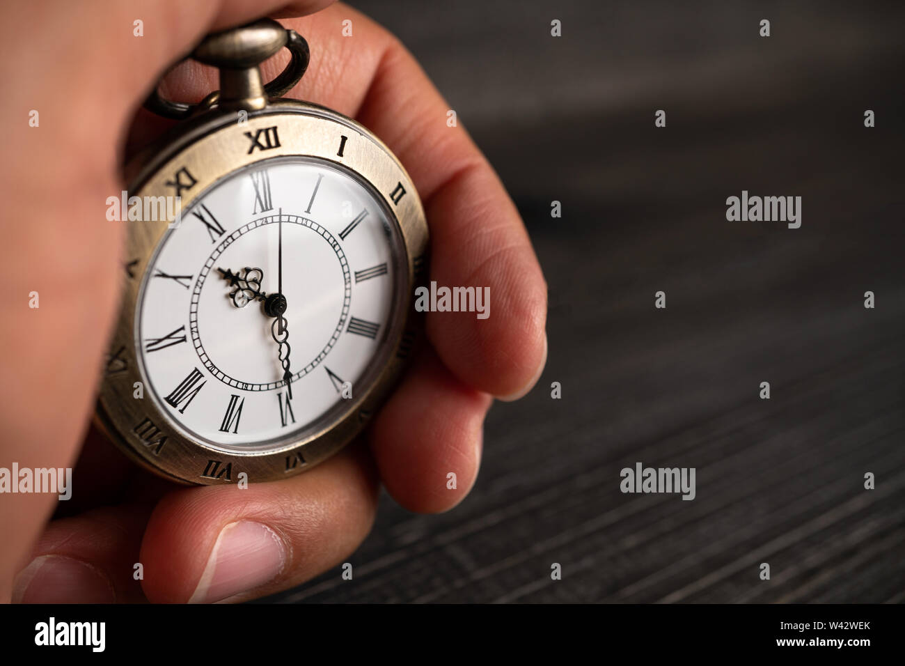 Men hands hold a pocket watch and a black background Stock Photo - Alamy