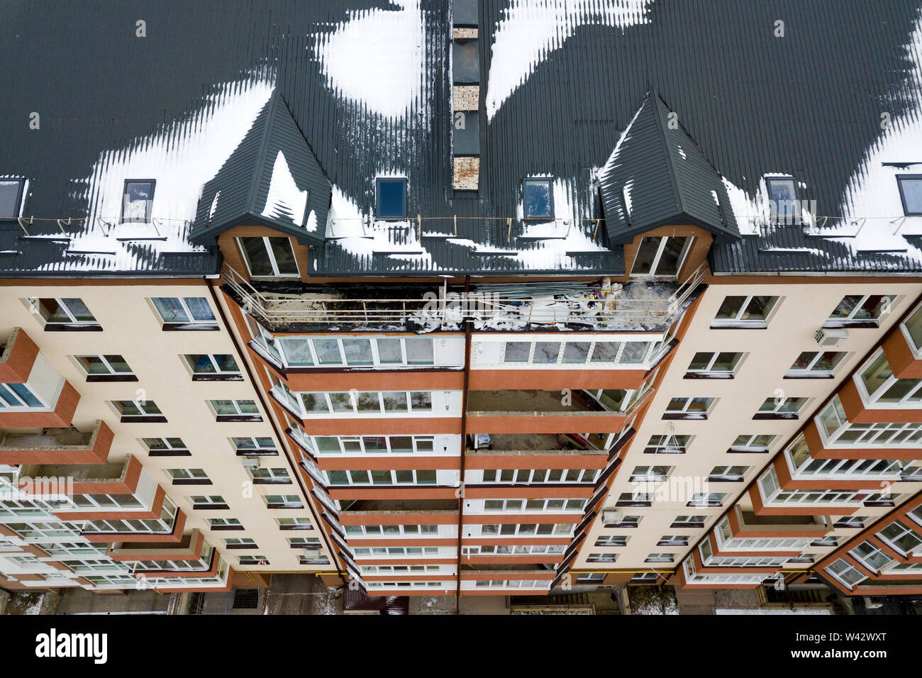 Aerial winter top view of tall apartment building, brick chimneys ...
