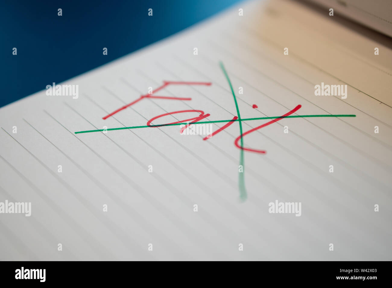 Fail text with a hand with a red pen And crossed out with a green pen ...