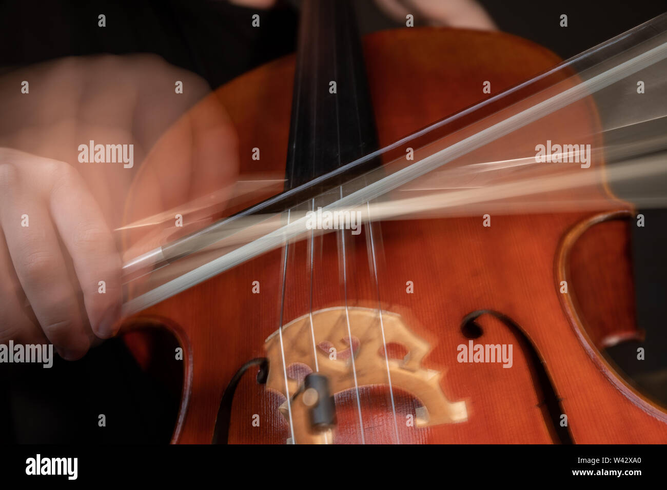 A young cellist practices intensely in this close up high resolution ...