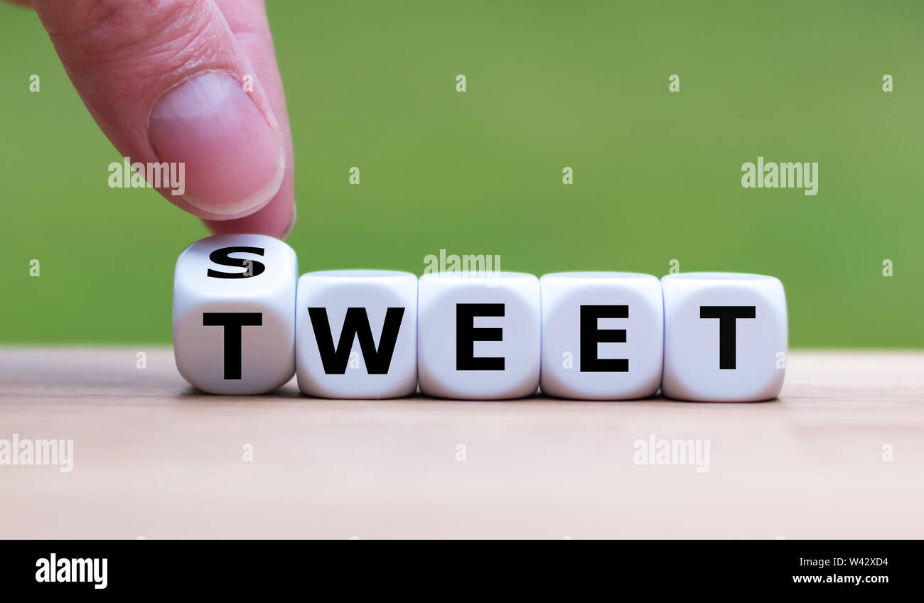 Hand turns a dice and changes the word "sweet" to "tweet Stock Photo ...