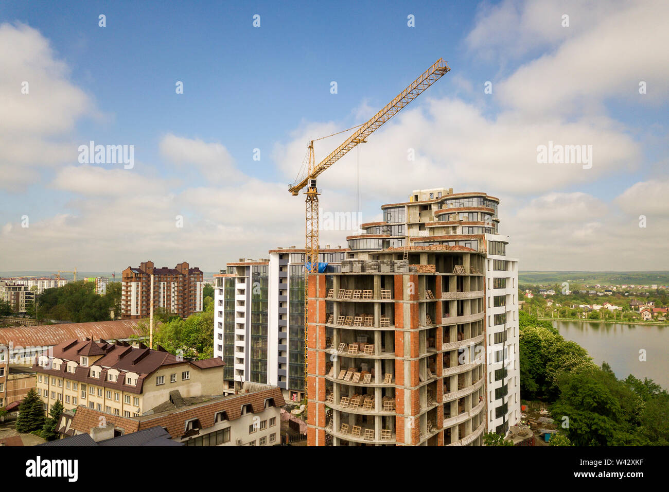 Apartment or office tall building under construction. Brick walls ...