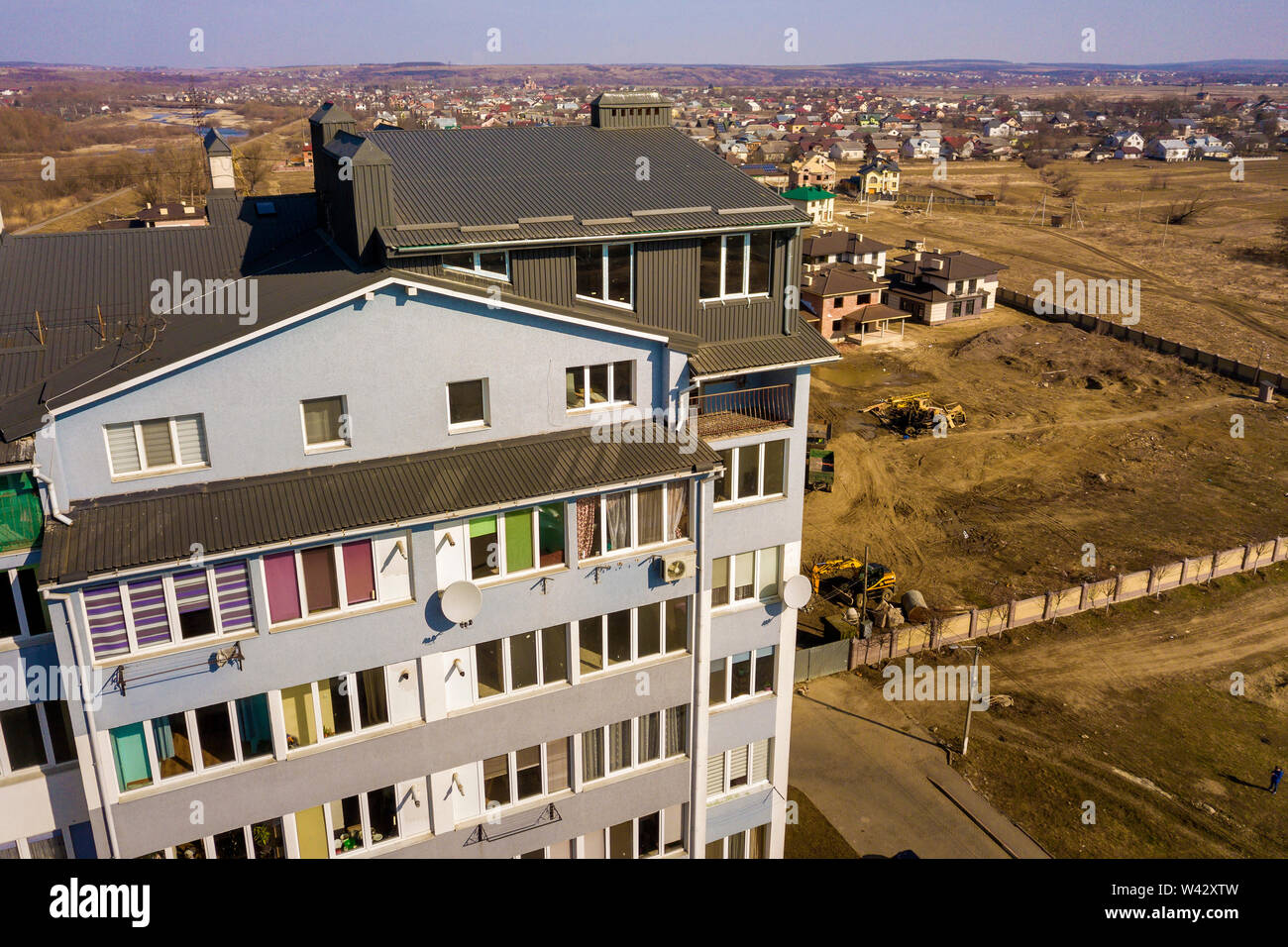 Aerial view of attic annex room exterior with plastic windows, roof and ...