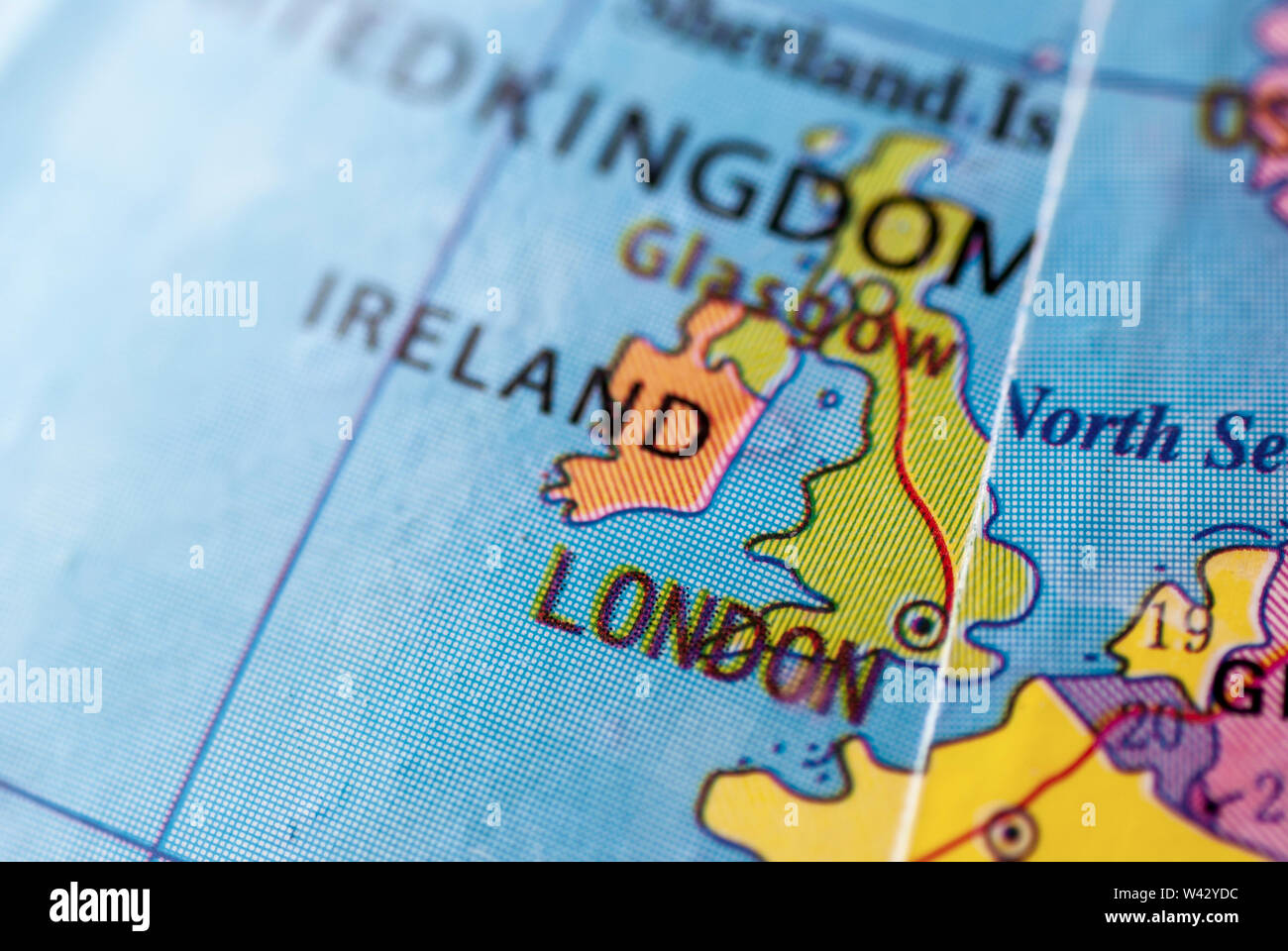 Focus to Great Britain and Ireland on a colorful world globe with copy ...