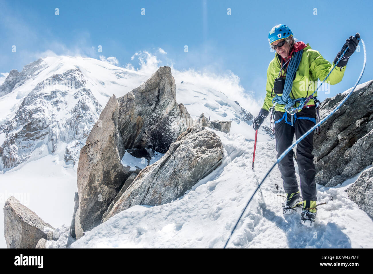 A mountaineer manages his rope during a bluebird climb on Mt Blanc ...