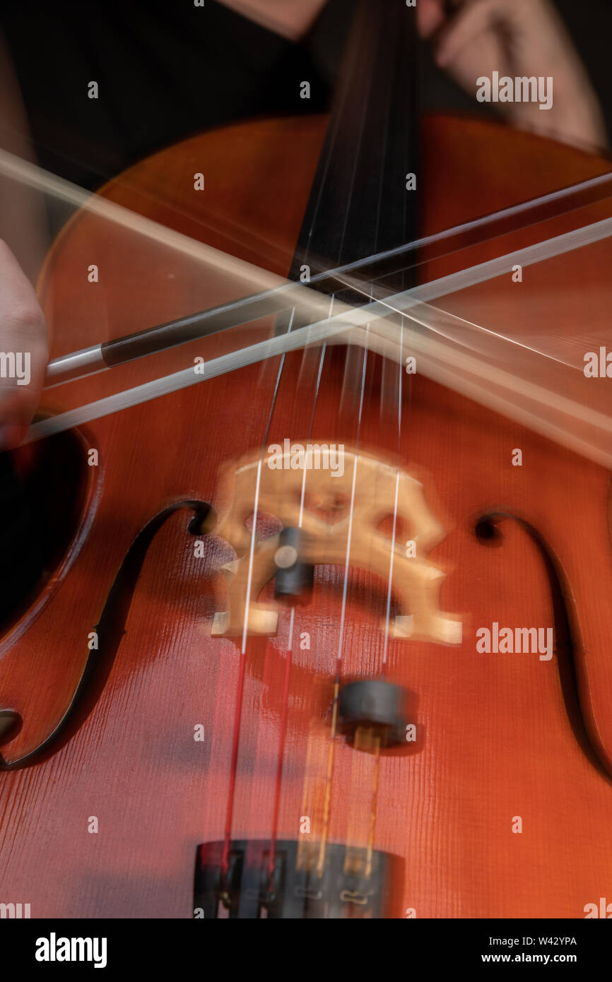 A young cellist practices intensely in this close up high resolution ...