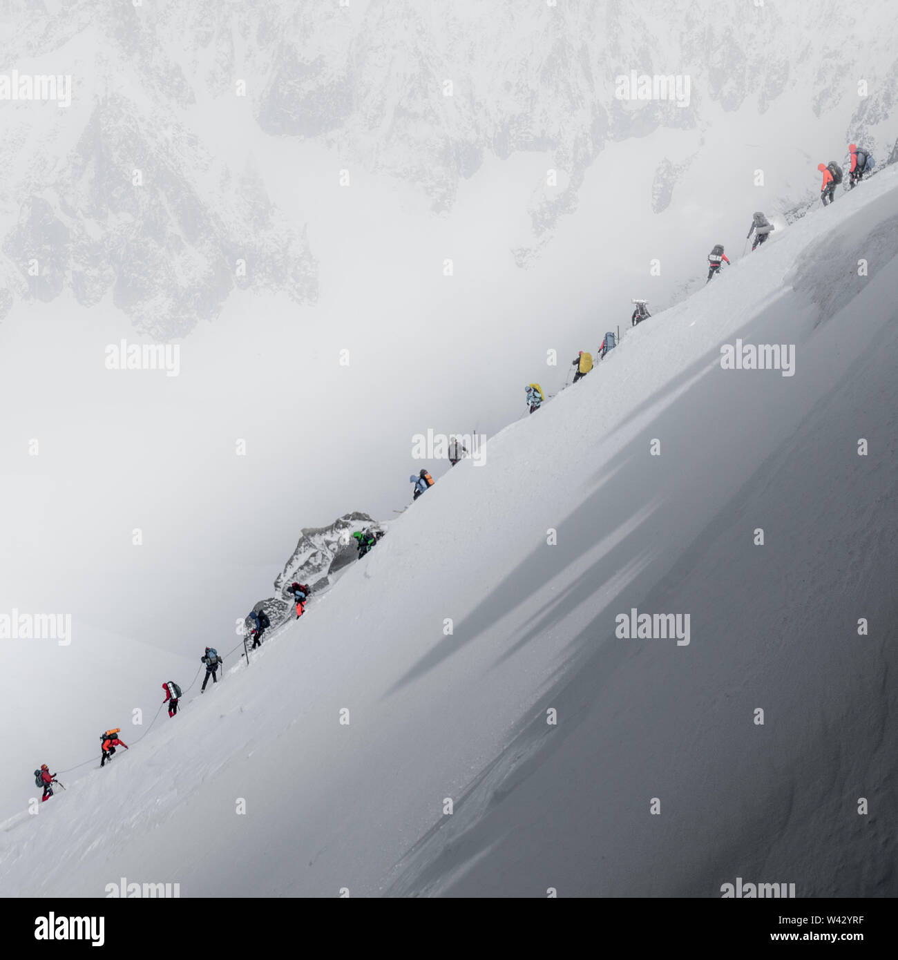 Traffic jam on Mt Blanc as a string of climbers navigate a steep ridge ...