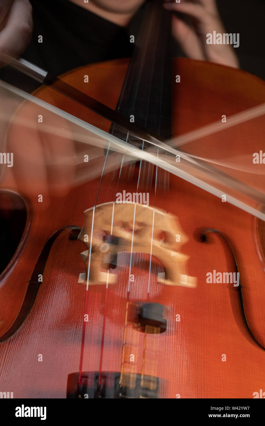 A young cellist practices intensely in this close up high resolution ...