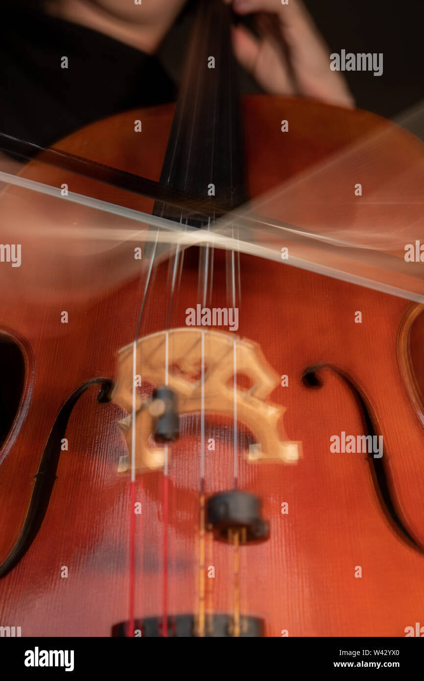 A young cellist practices intensely in this close up high resolution ...
