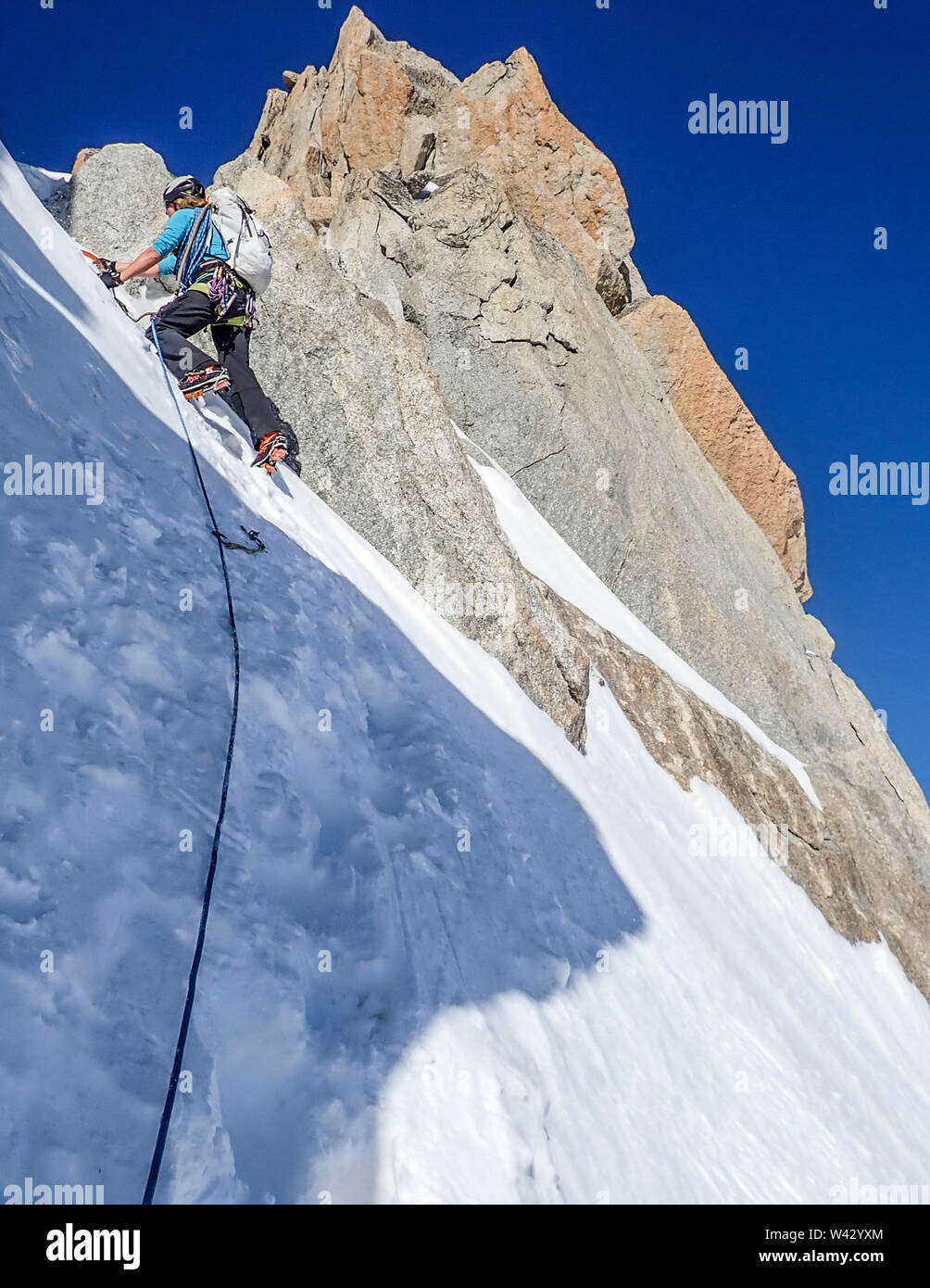 A woman alpinist leads a pitch of steep snow & ice on the Forbes Arete ...