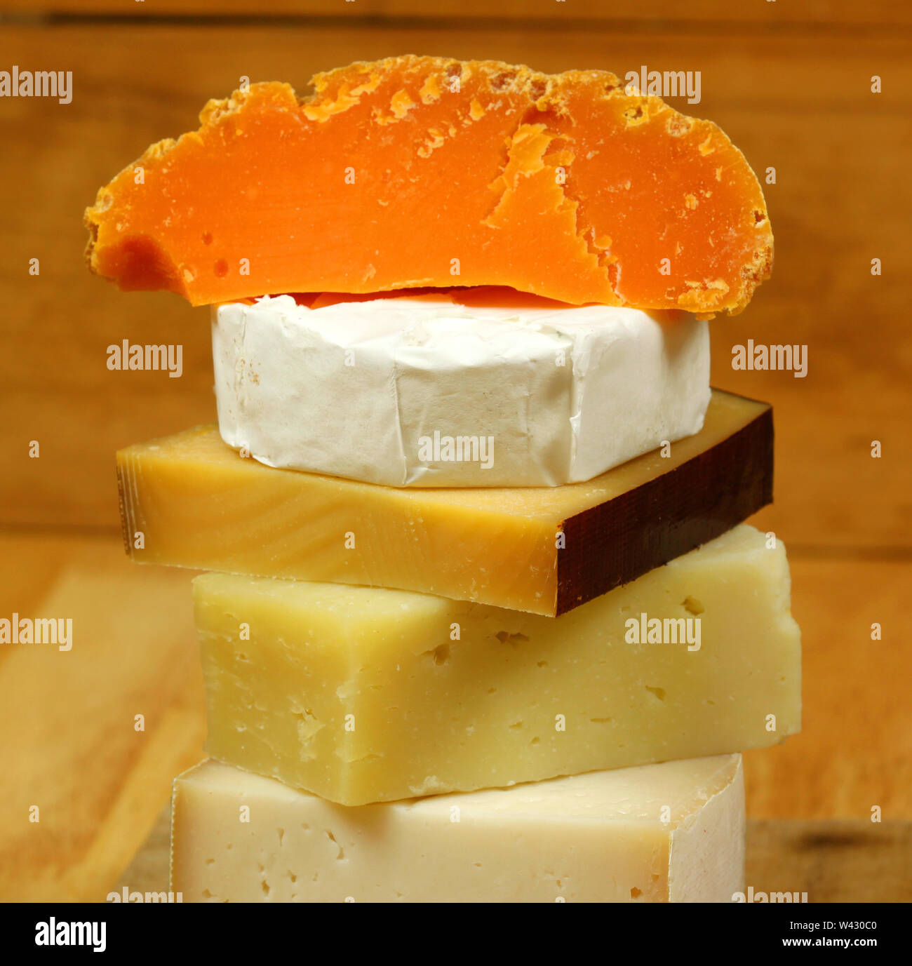 Closeup of various types of cheese forming tower Stock Photo - Alamy