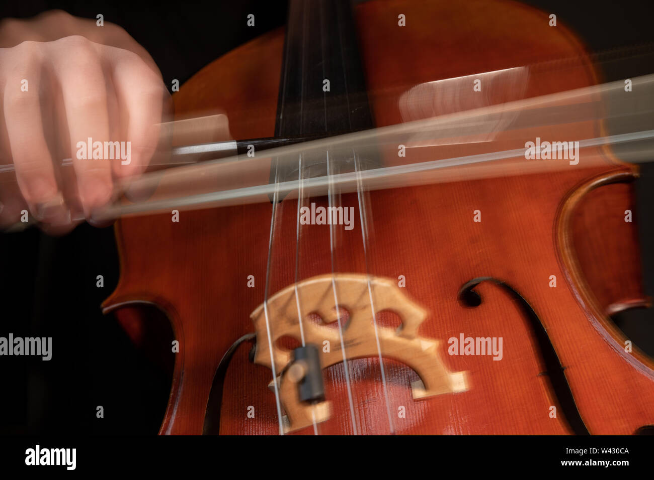 A young cellist practices intensely in this close up high resolution ...