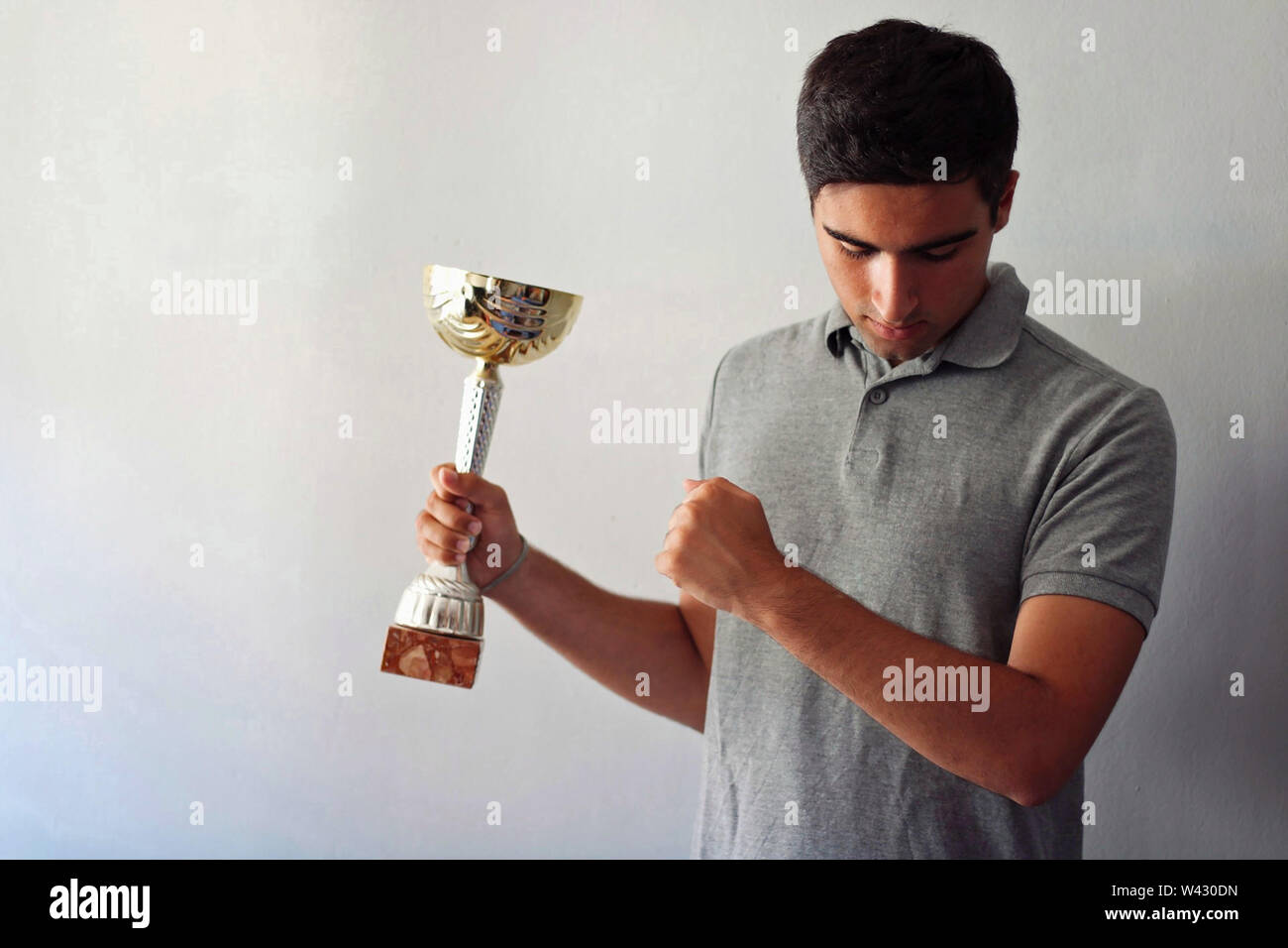 Man holding trophy cup hi-res stock photography and images - Alamy