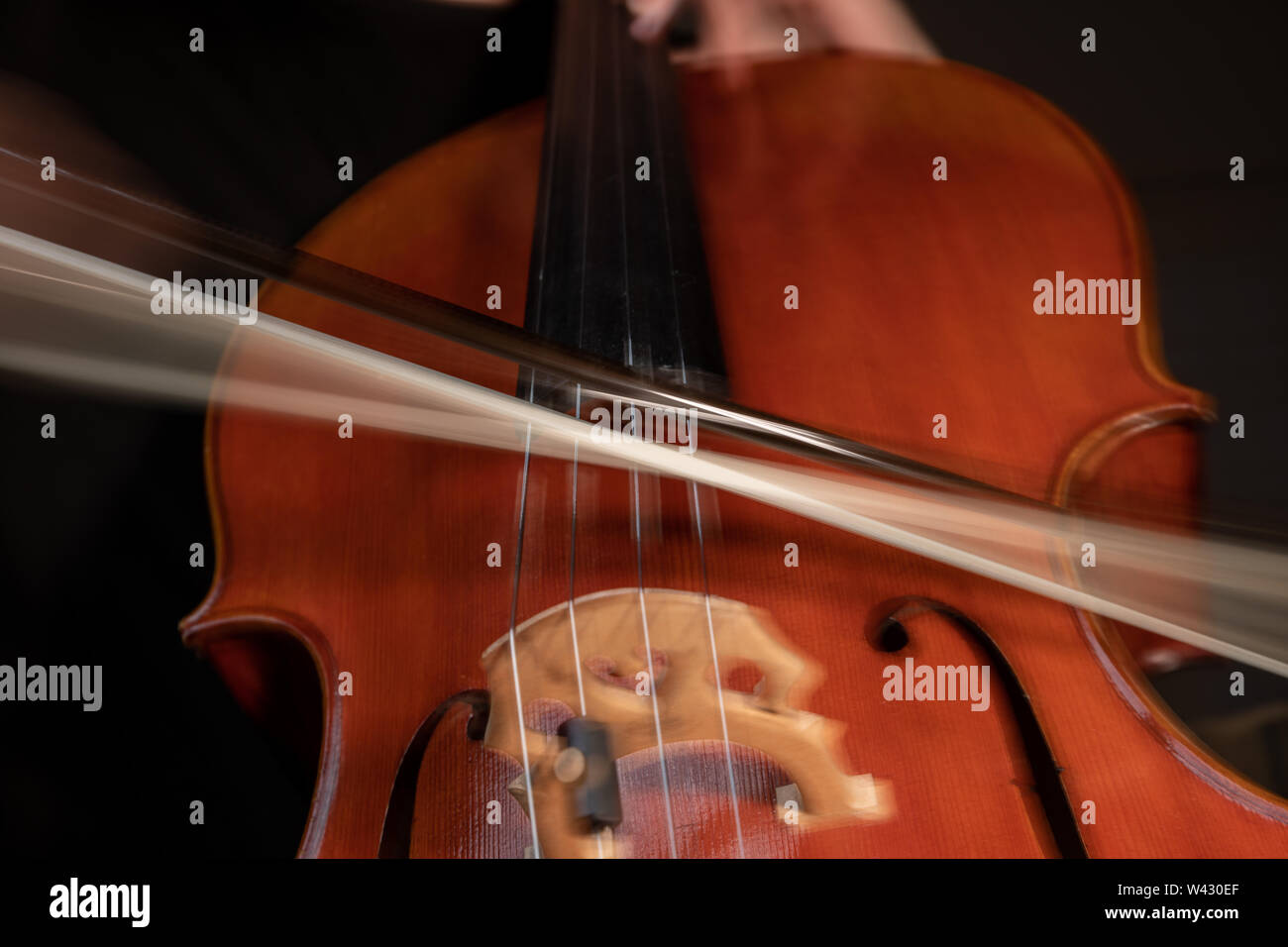 A young cellist practices intensely in this close up high resolution ...