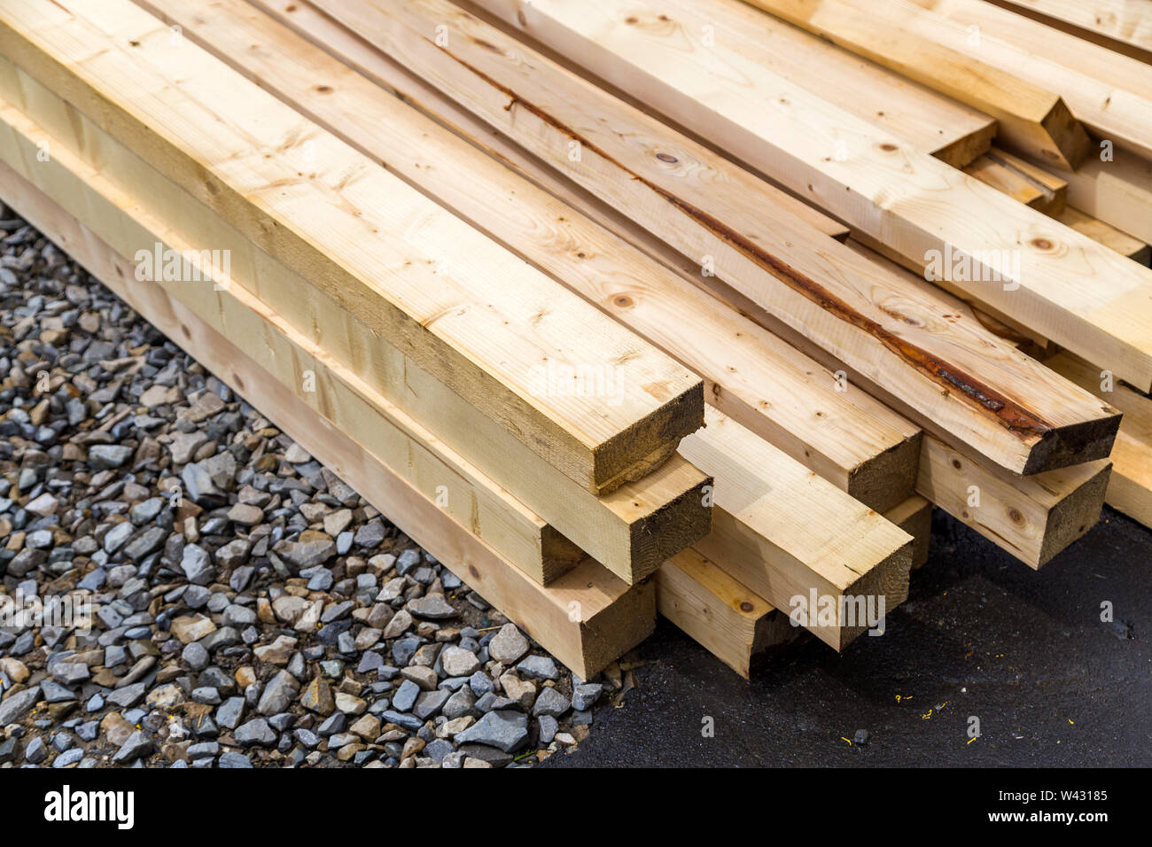 Stack of natural wooden boards on building site. Industrial timber for ...