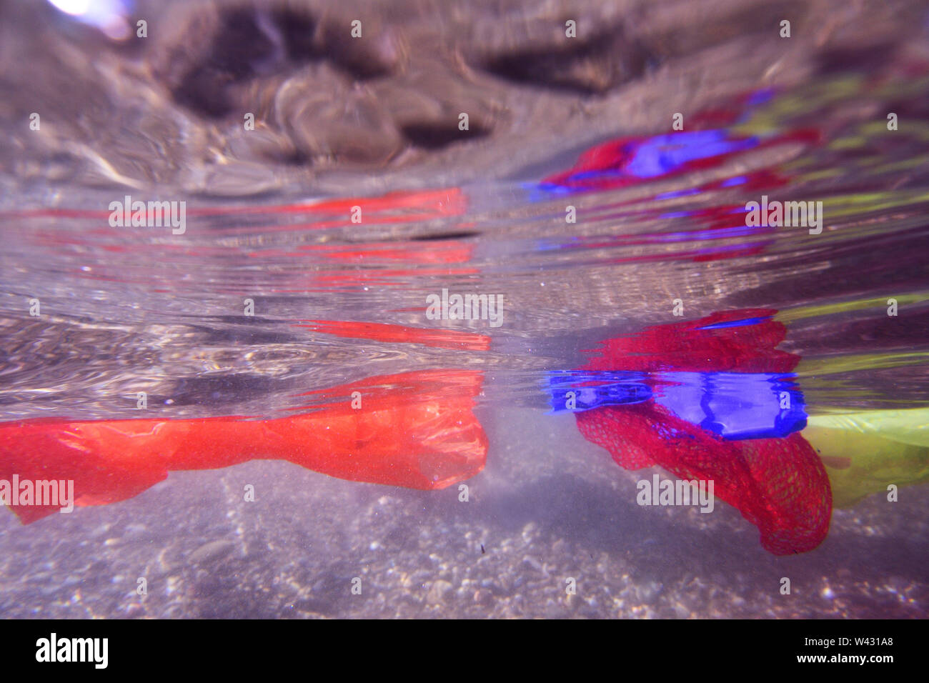 colored plastics on a beach Stock Photo - Alamy