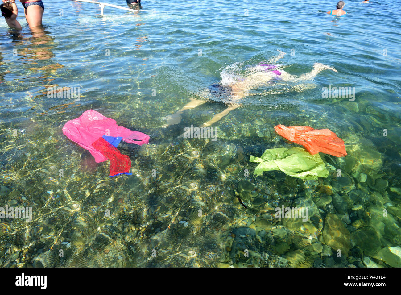 woman diving in the sea with garbage Stock Photo - Alamy
