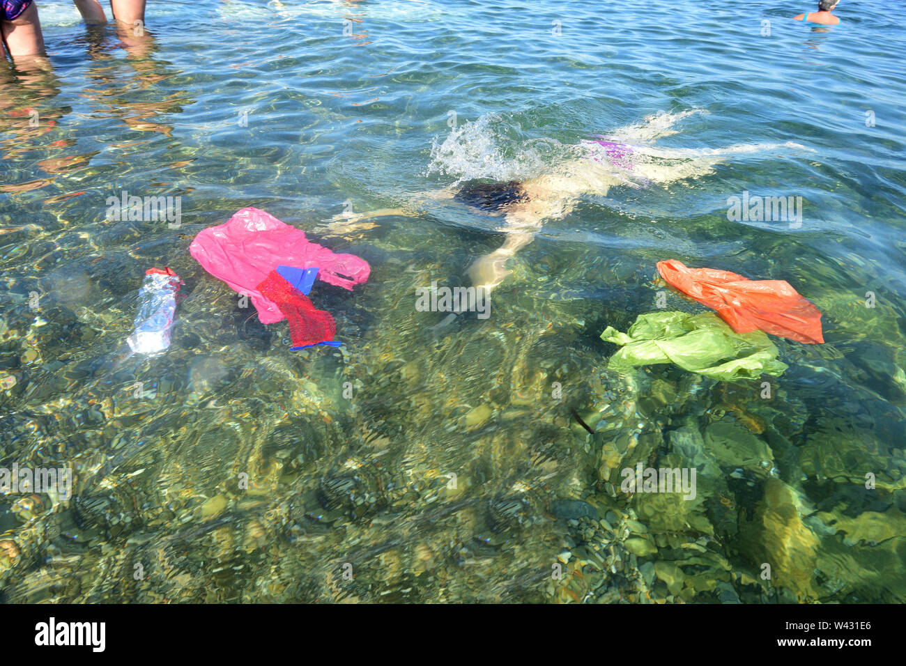 woman diving in the sea with garbage Stock Photo - Alamy