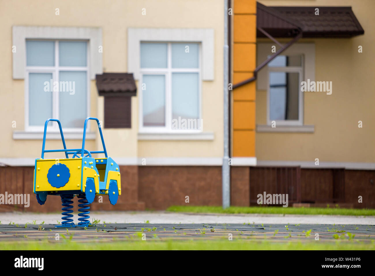Kindergarten playground with bright toy car on spring. Children ...