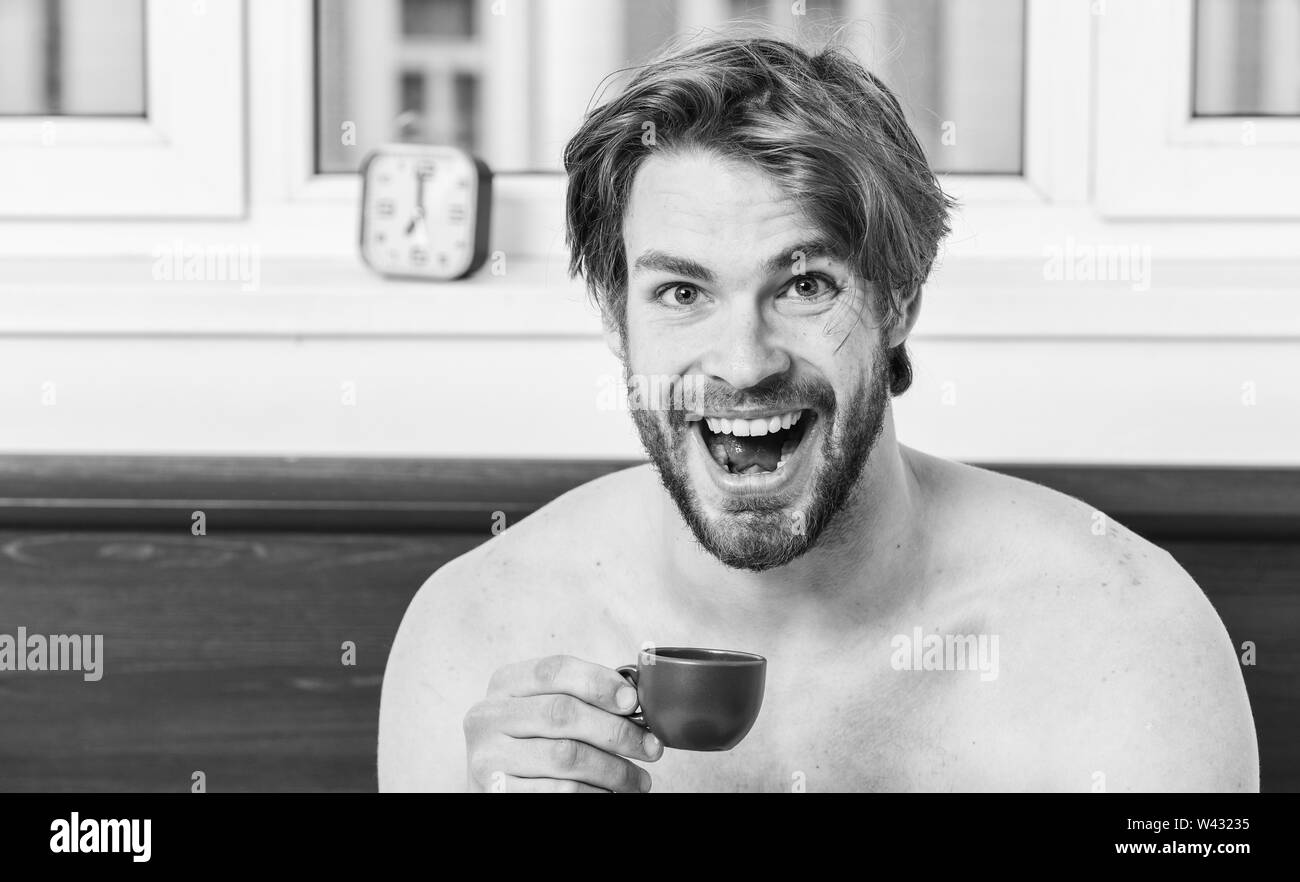 Every morning with his coffee. Man bearded handsome macho hold cup of ...