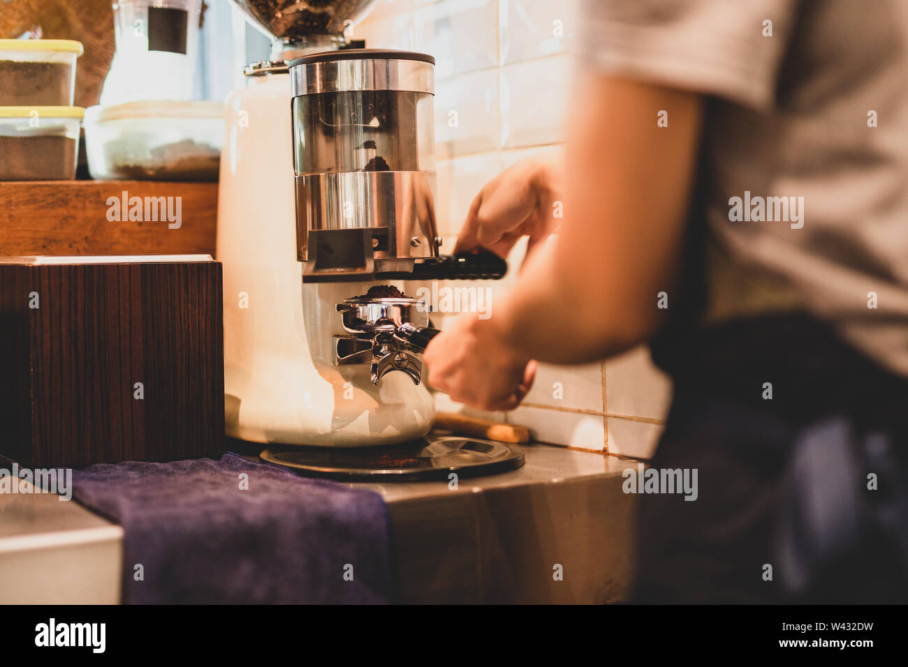 Barista grinding coffee beans using hi-res stock photography and images ...