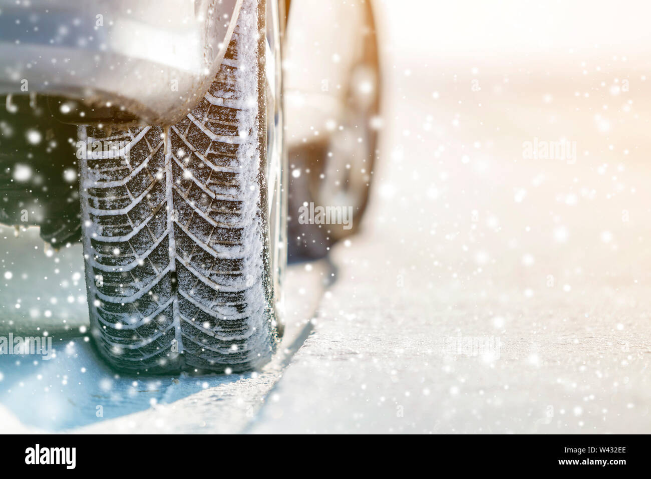 Close-up of car wheels rubber tires in deep winter snow. Transportation ...