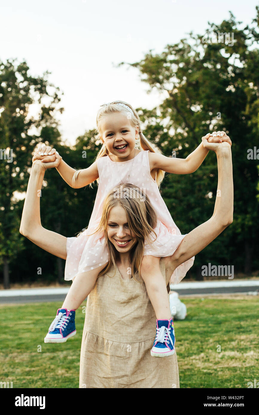 Portrait of a mother carrying her daughter Stock Photo - Alamy