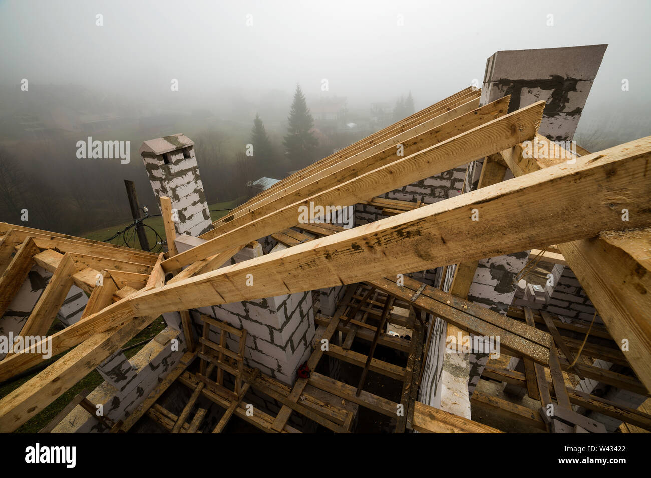 Top view of roof frame from wooden lumber beams and planks on walls ...