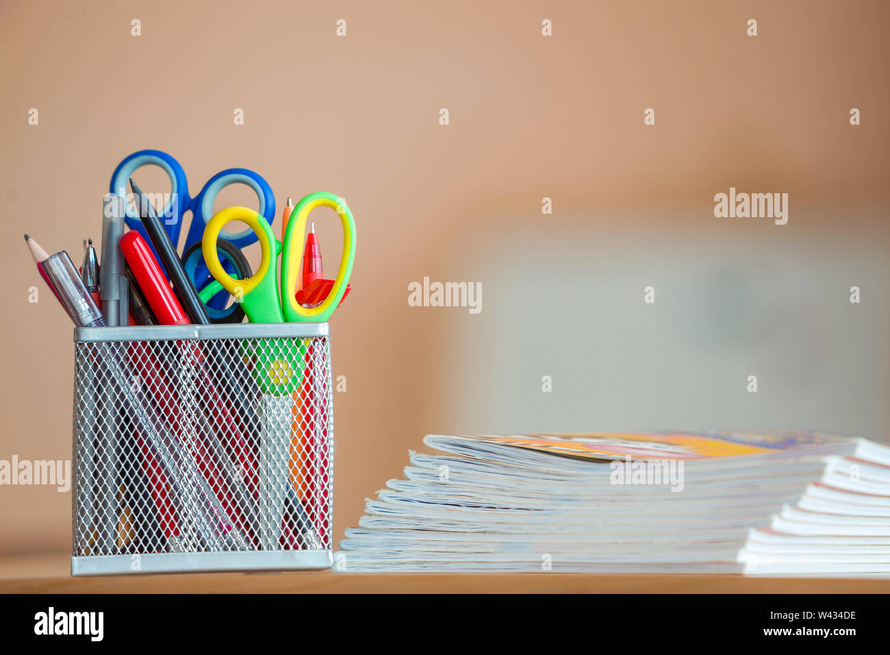 Stack of notebooks and stationery arrangement in classroom or office on ...