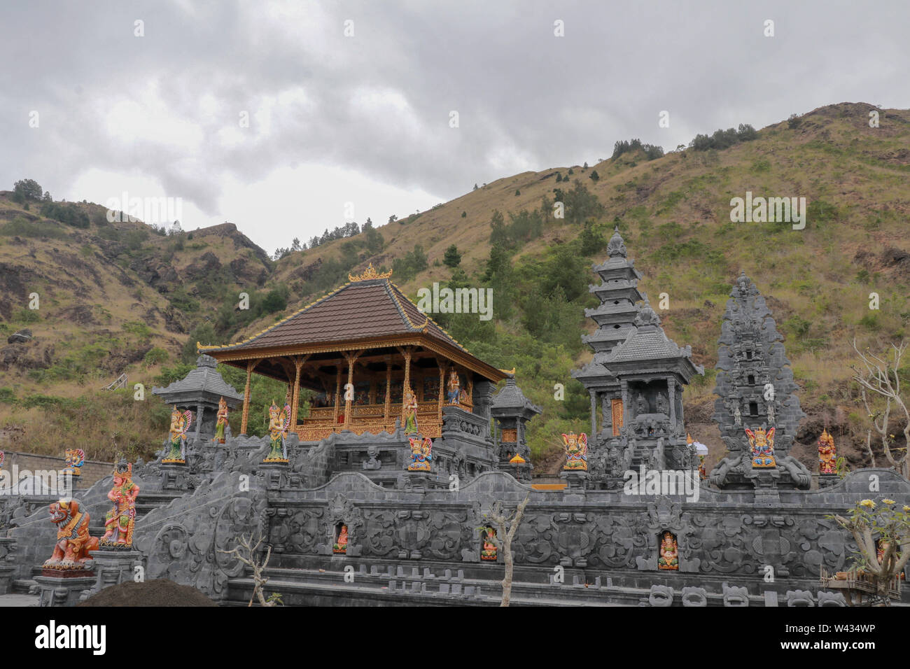 Hindu temple at the foot of Batur volcano. Believers build a new temple ...